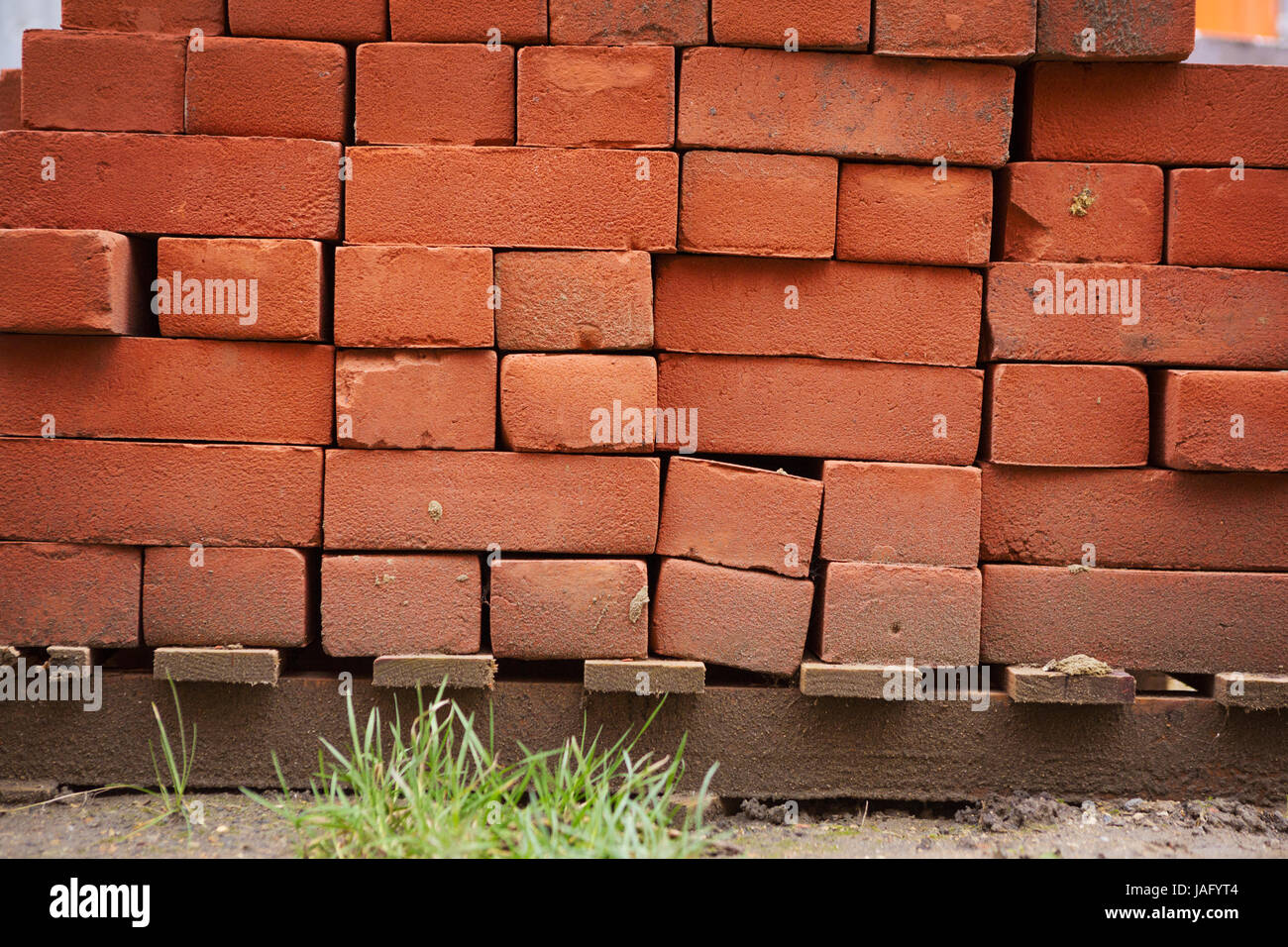 Stack of red bricks on a building site Stock Photo - Alamy