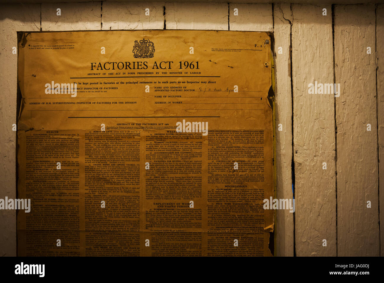 Yellowed poster of the Factories Act from 1961 on a wall in a shoemaker ...