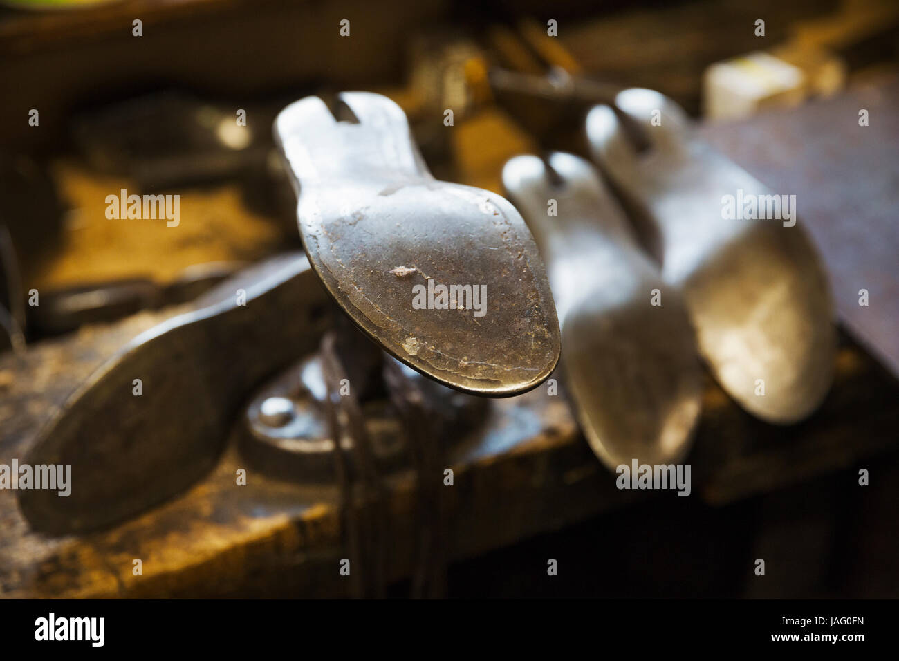 Close up of various metal shoe forms, shoe lasts in a shoemaker's ...