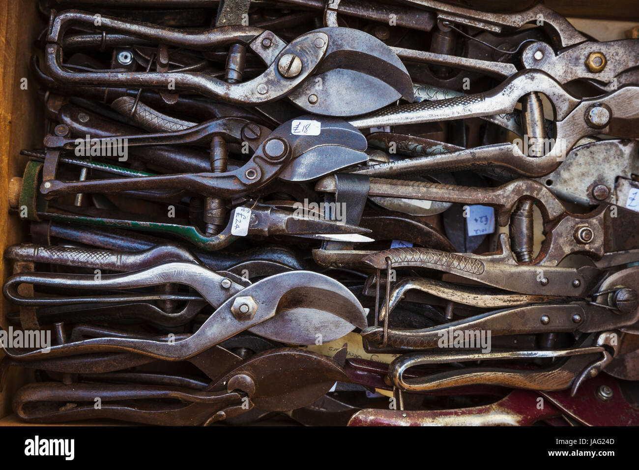 Overhead view of a box of old rusty worn metal shears, tin snips and ...