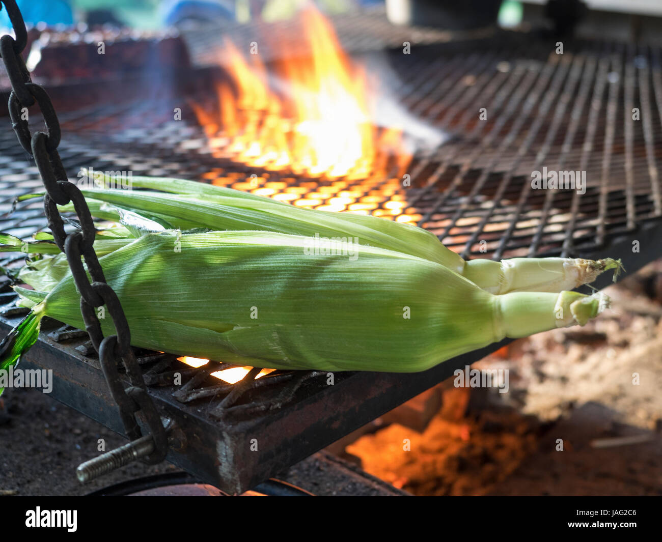 Sweetcorn roasting on a barbeque outdoors Stock Photo - Alamy