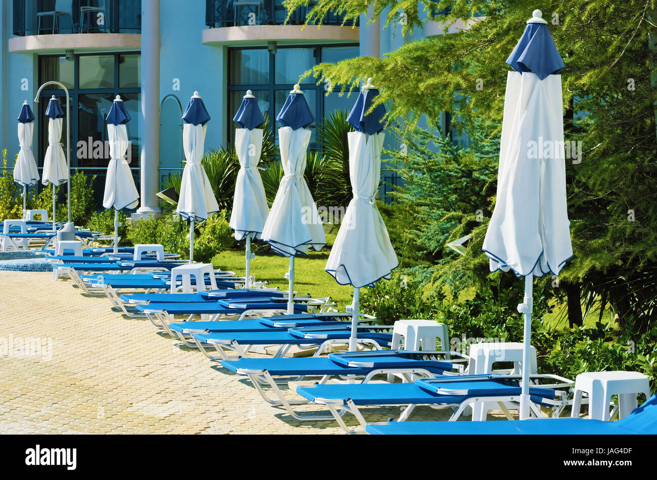 A Row Of Empty Sunbeds With Umbrellas In The Resort Stock Photo - Alamy