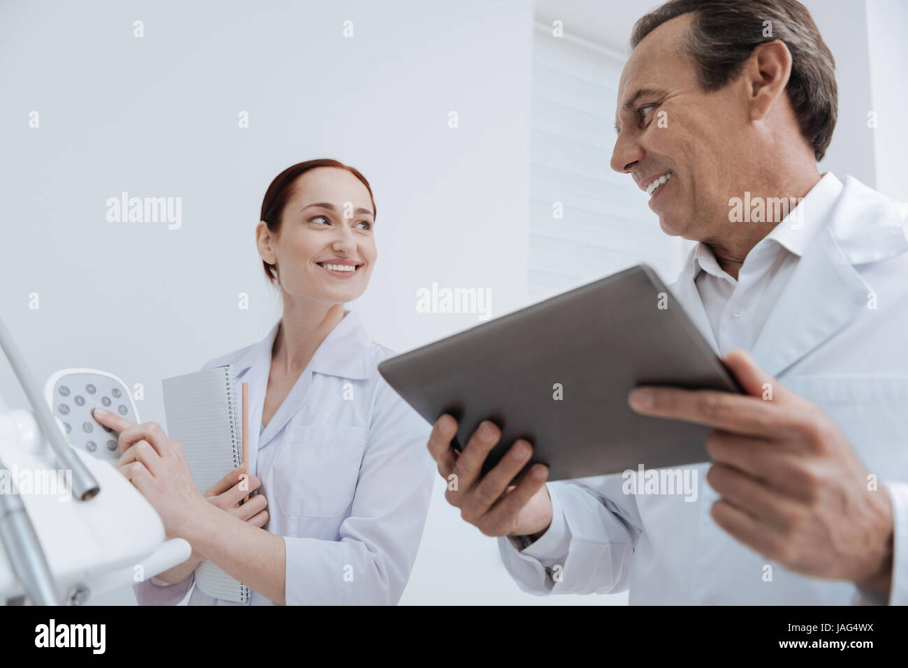 Good for you. Smiling female intern standing opposite her mentor and ...