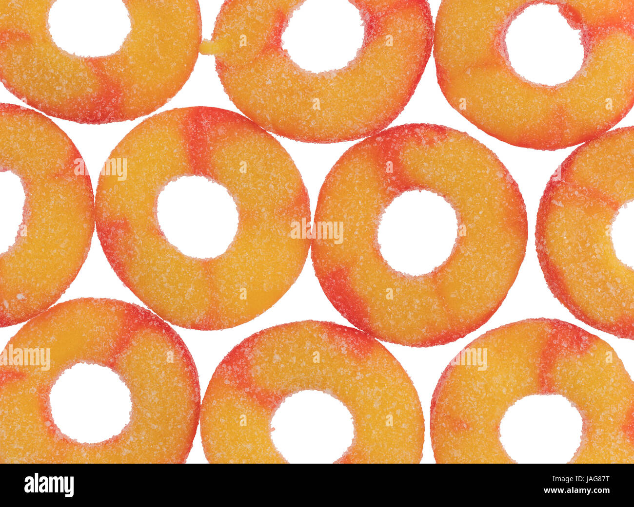A layer of peach flavored candy rings isolated on a white background ...