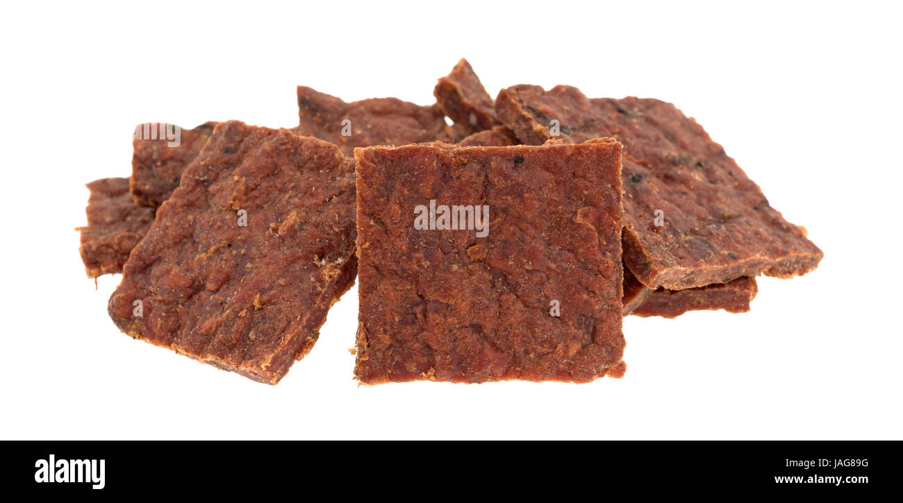 A small pile of peppered beef jerky pieces isolated on a white ...