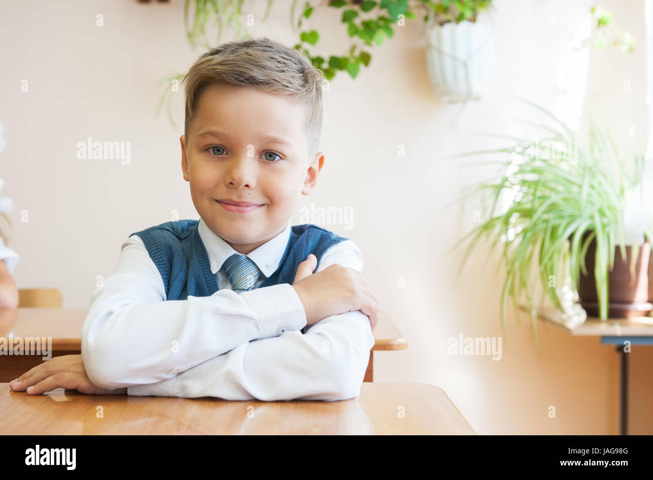 The first time in first class: happy schoolboy at school background ...