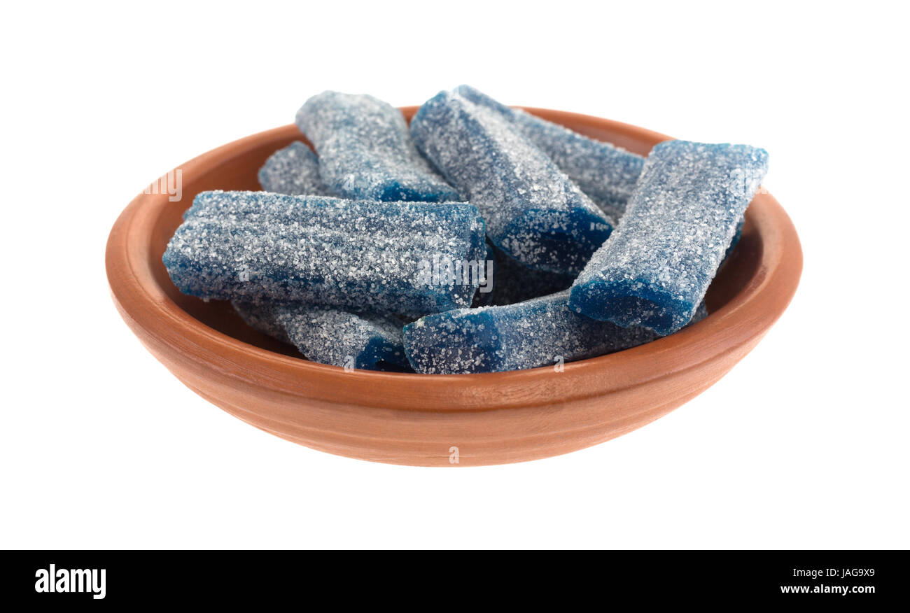 Blue gummy sweet and sour sugar candy in a bowl isolated on a white ...