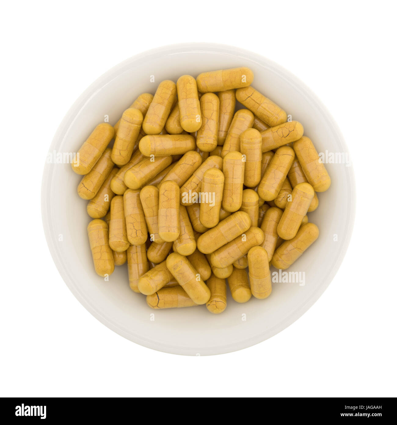 Top view of turmeric capsules in a small bowl isolated on a white ...