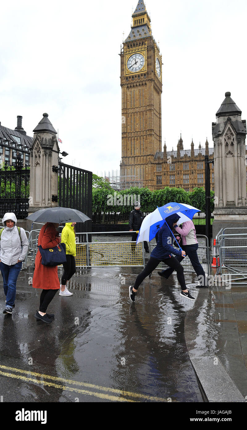 A girl jumps over a puddle of rain water outside the Palace of ...