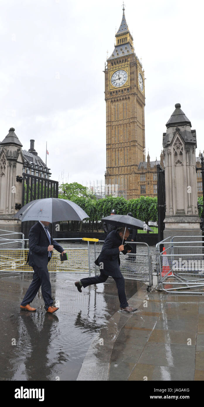 A man jumps over a puddle of rain water outside the Palace of ...