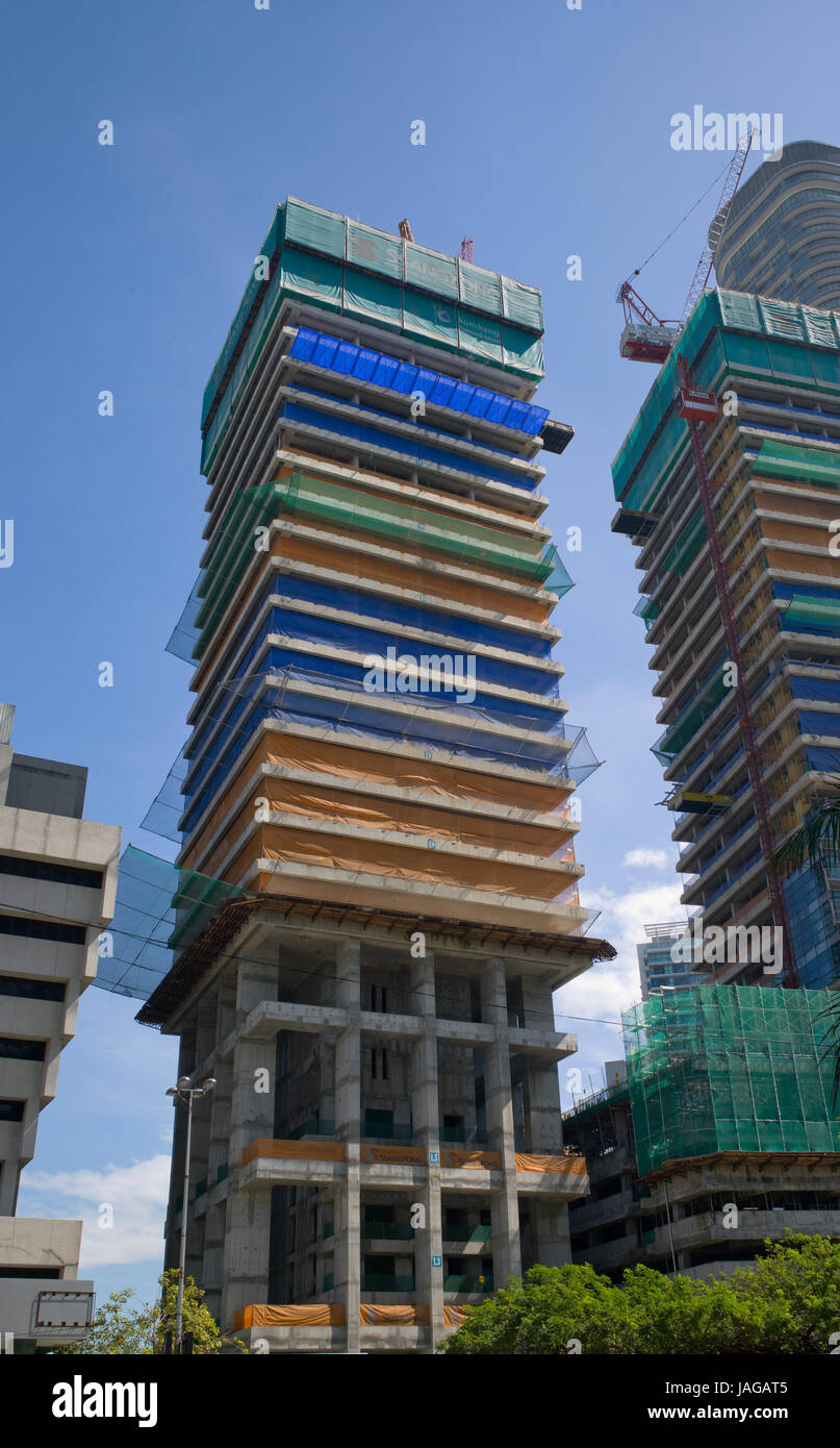 Multi coloured scaffolding netting around high rise buildings under ...
