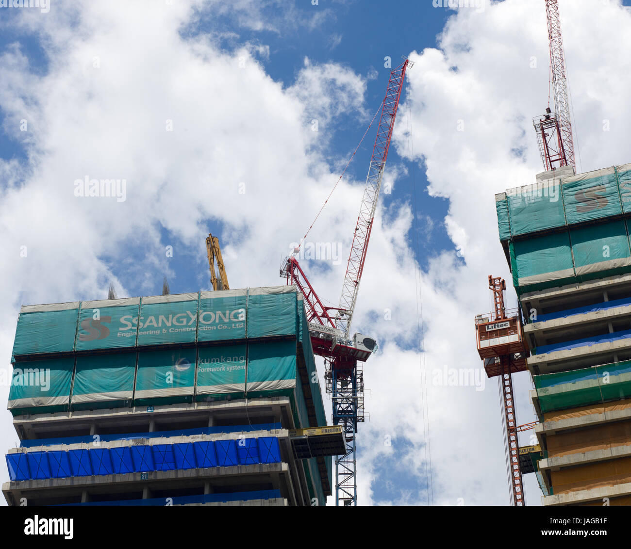 Multi coloured scaffolding netting around high rise buildings under ...