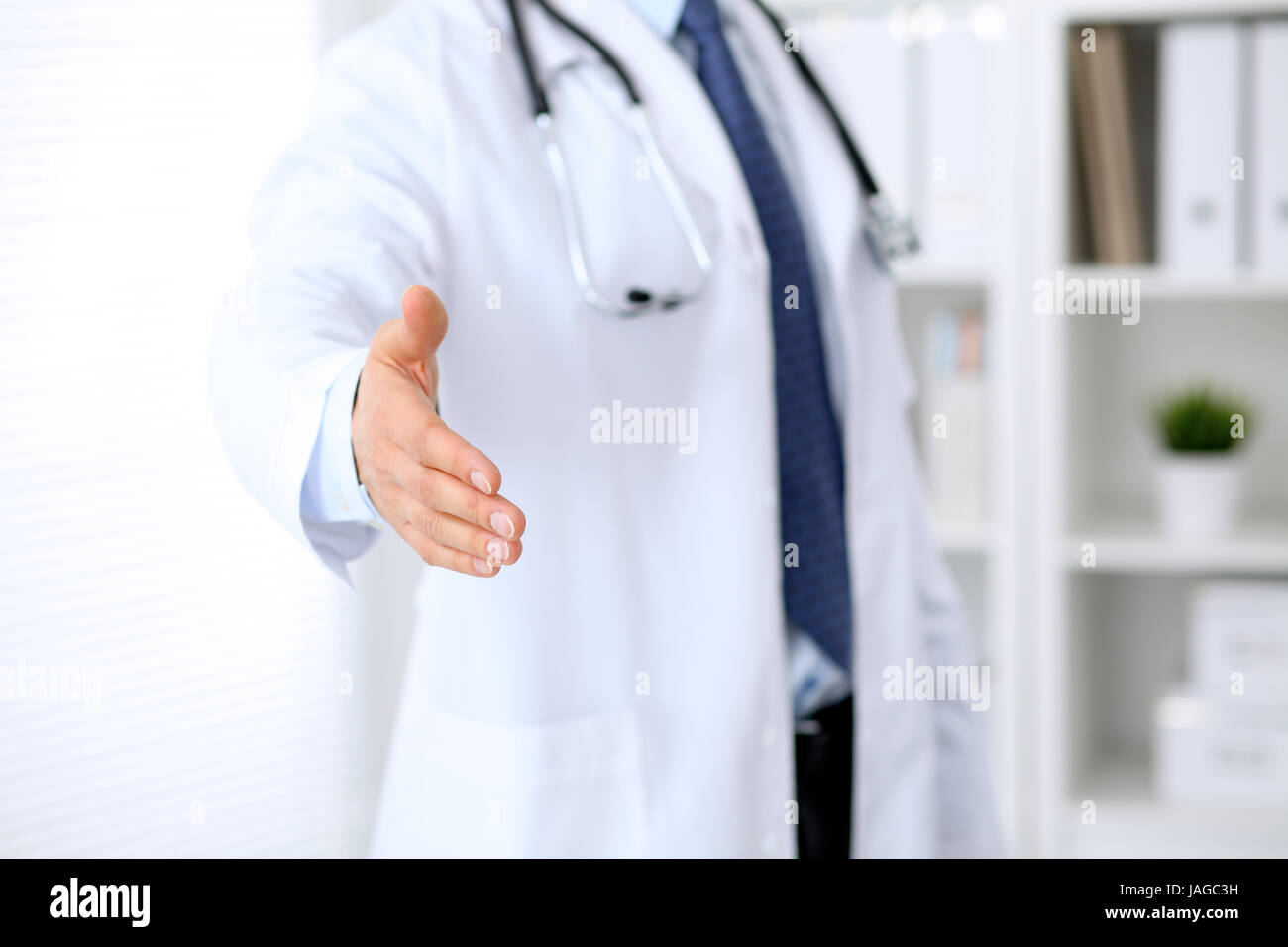 Male medicine doctor offering helping hand for handshake. Partnership ...