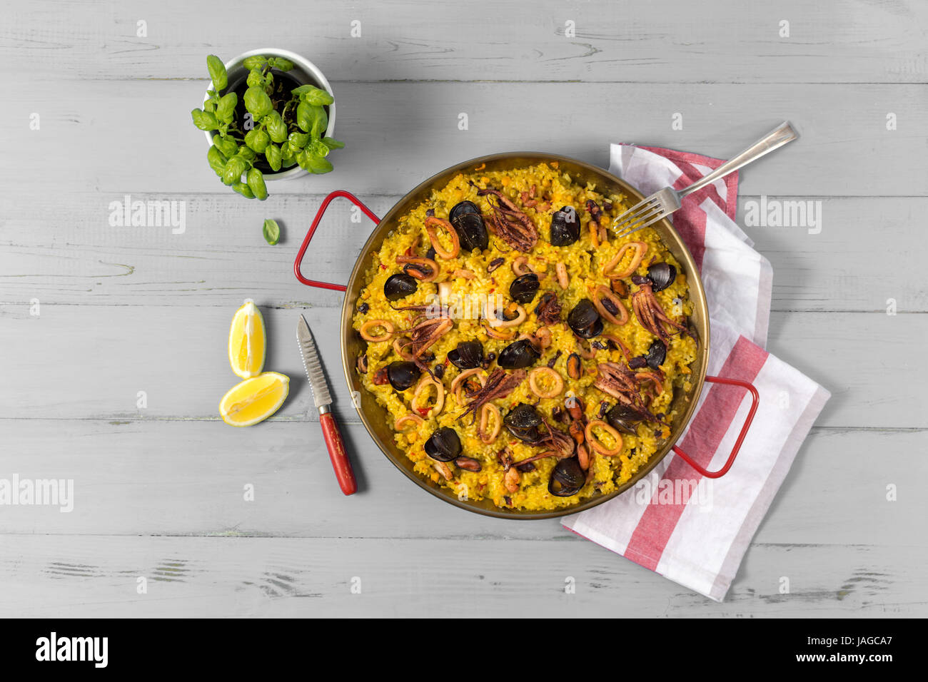 Seafood Paella in Traditional Pan on Rustic Wooden Table Stock Photo ...