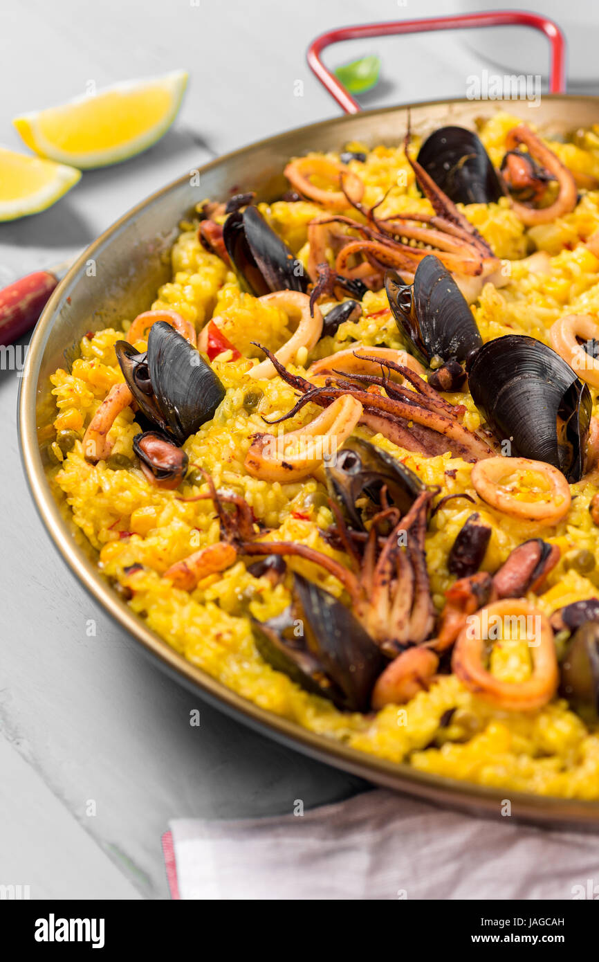 Seafood Paella in Traditional Pan on Rustic Wooden Table Stock Photo ...