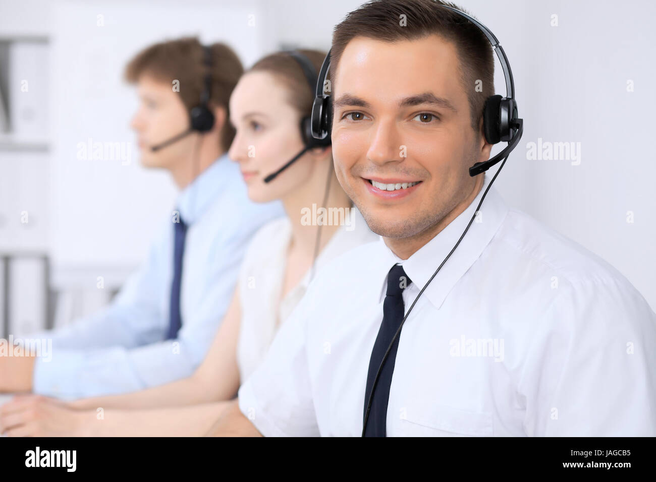 Young business man in headset. Call center Stock Photo - Alamy
