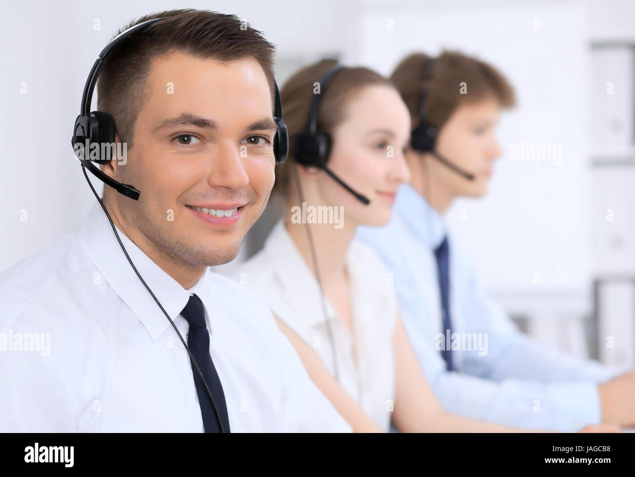 Young business man in headset. Call center Stock Photo - Alamy