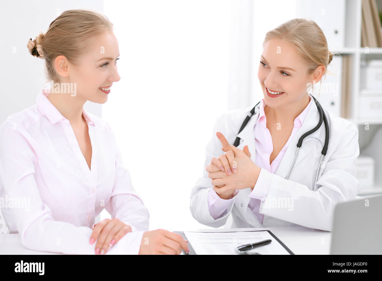 Doctor and patient sitting at the desk Stock Photo - Alamy