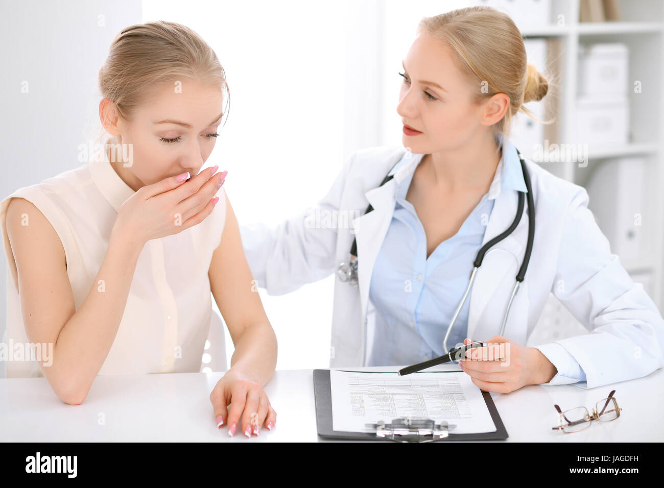 Doctor and patient sitting at the desk Stock Photo - Alamy
