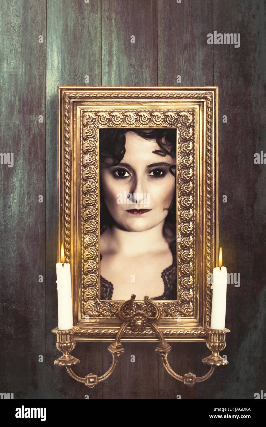 Reflection of woman in ornate gold mirror with lit candles Stock Photo ...