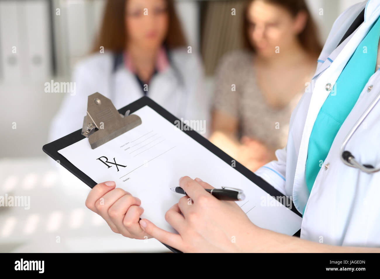 Close-up of a female doctor while filling up medical prescription Stock ...