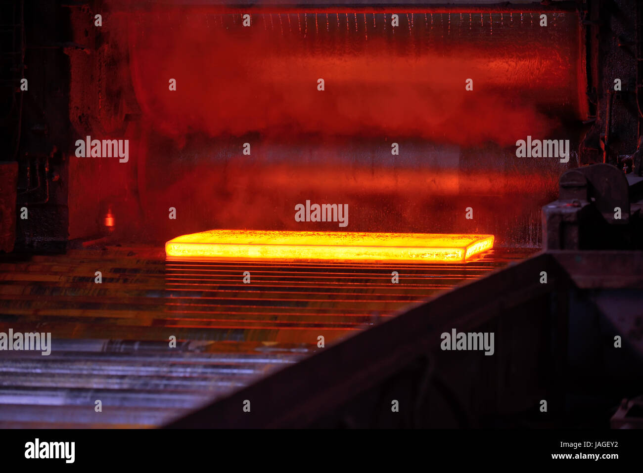 Hot steel plate on conveyor Stock Photo - Alamy