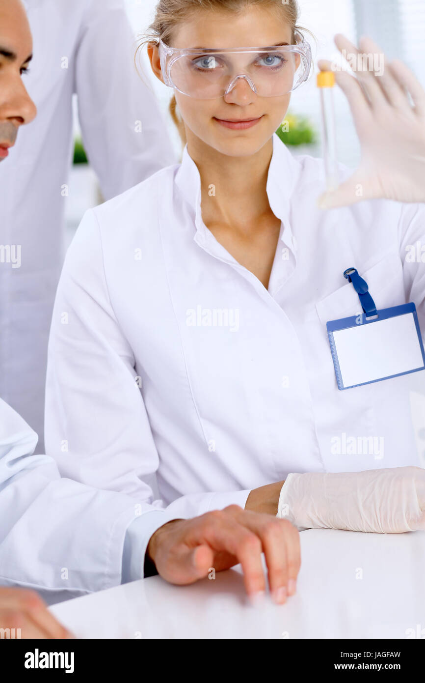 Scientific research team with clear solution in laboratory Stock Photo ...