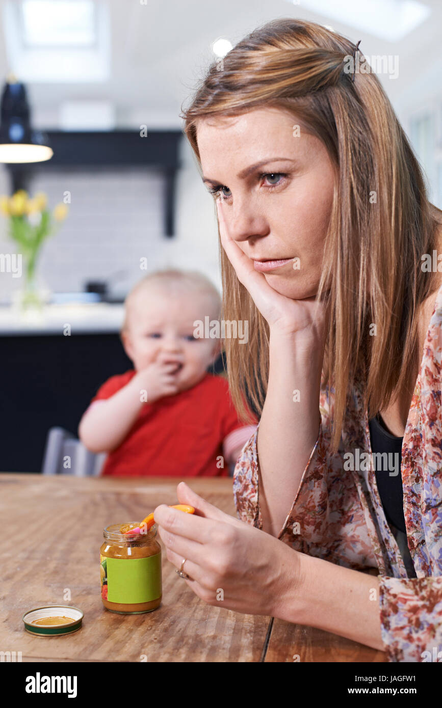 Stressed parent feeding baby hi-res stock photography and images - Alamy