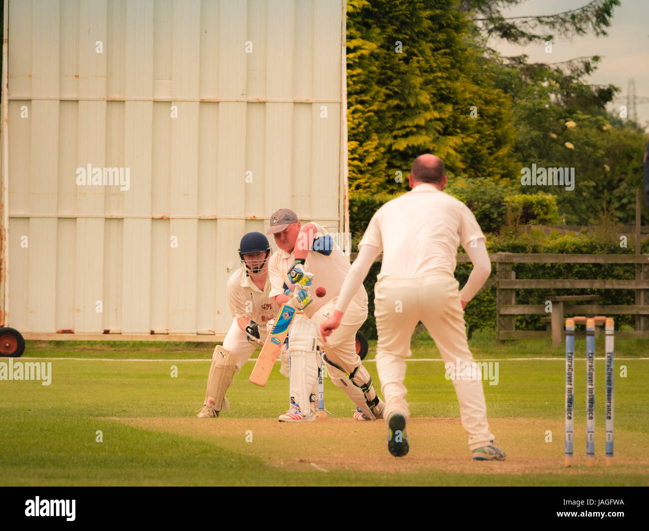 Game of Cricket being played in typical British village Stock Photo - Alamy