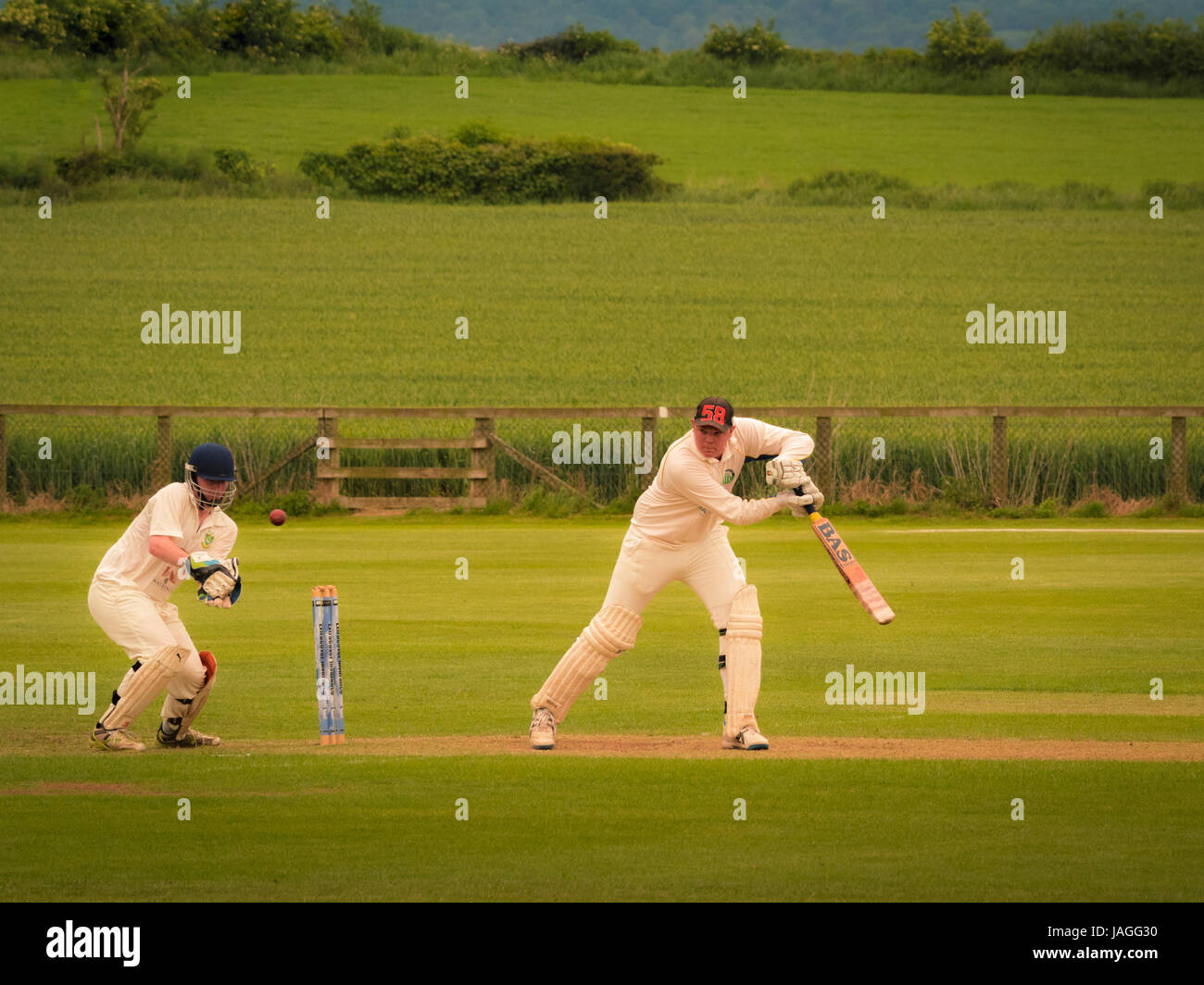 Game of Cricket being played in typical British village Stock Photo - Alamy