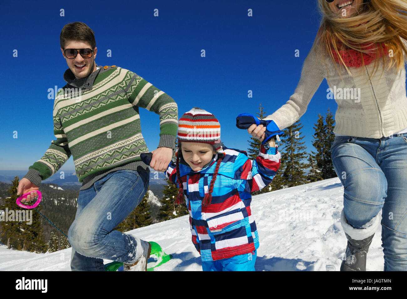 Winter season. Happy family having fun on fresh snow on vacation Stock ...