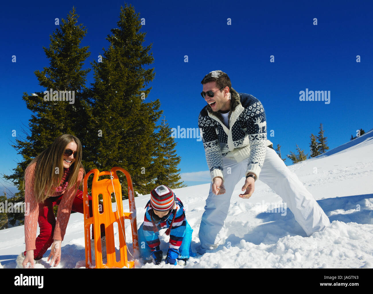 Winter season. Happy family having fun on fresh snow on vacation Stock ...