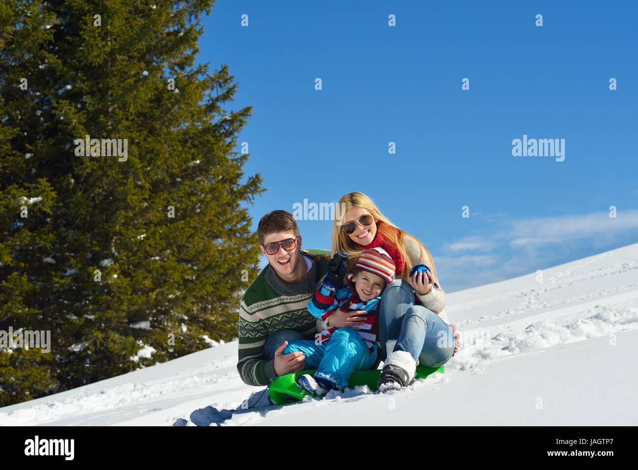 Winter season. Happy family having fun on fresh snow on vacation Stock ...