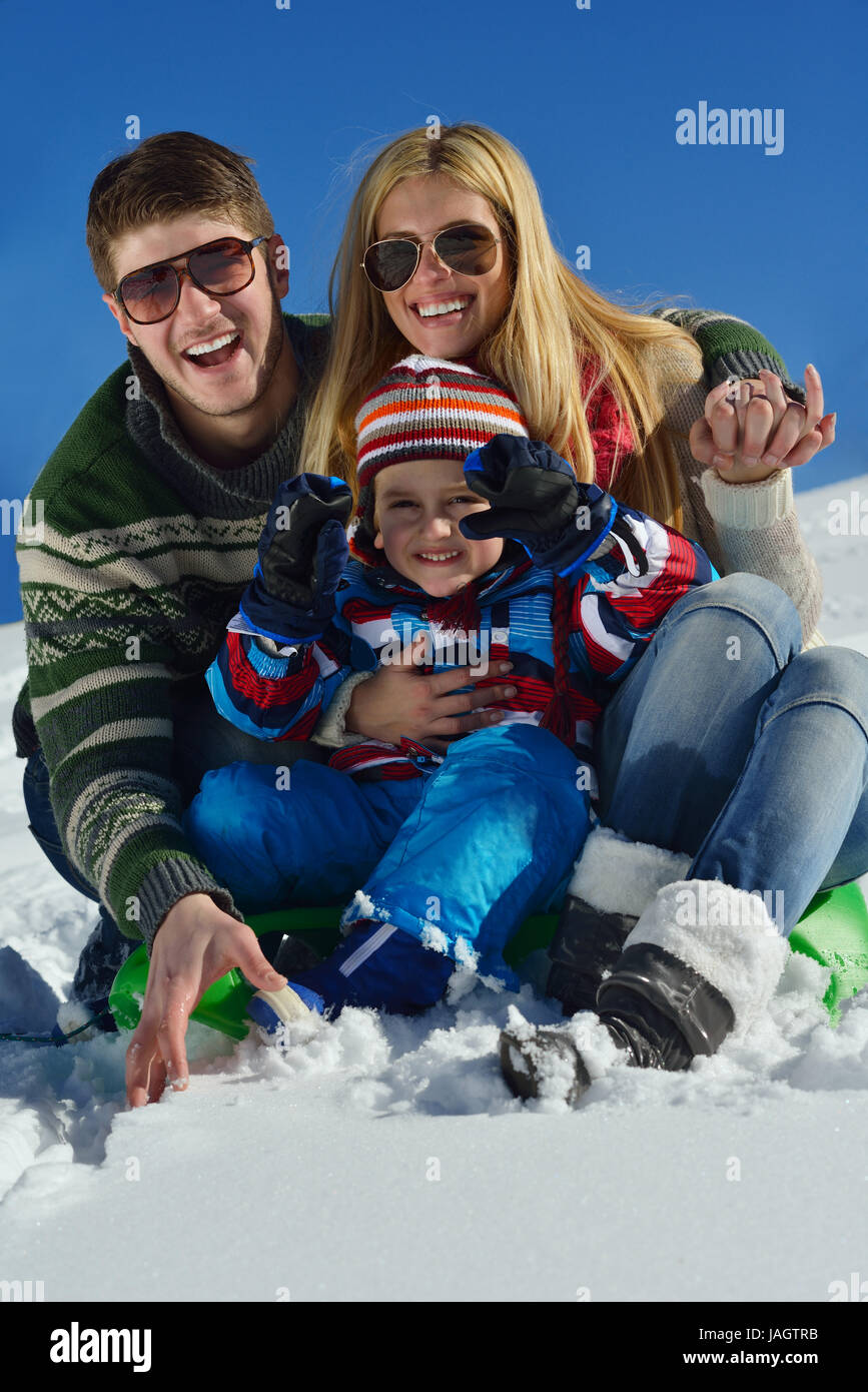 Winter season. Happy family having fun on fresh snow on vacation Stock ...