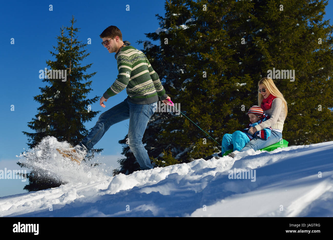 Winter season. Happy family having fun on fresh snow on vacation Stock ...