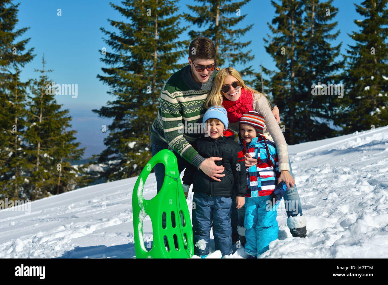 Winter season. Happy family having fun on fresh snow on vacation Stock ...