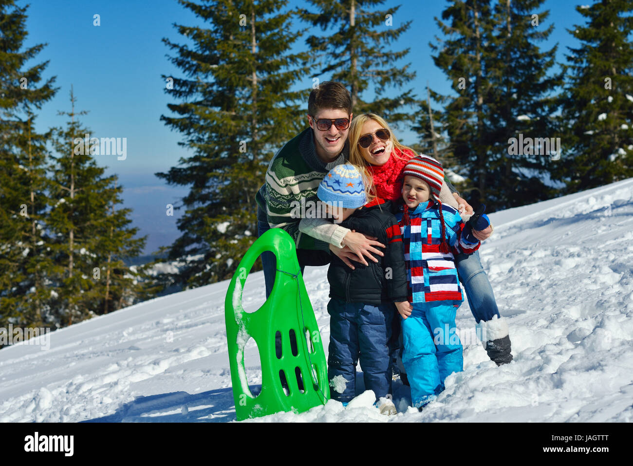 Winter season. Happy family having fun on fresh snow on vacation Stock ...