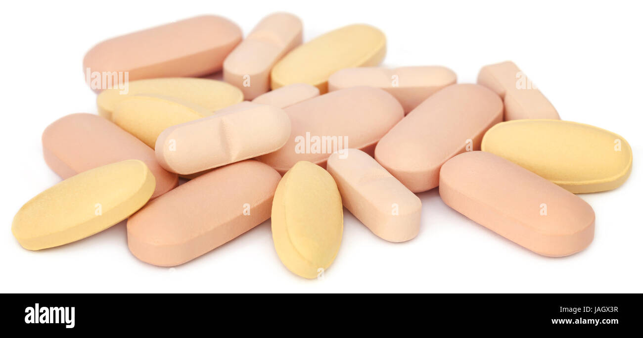 Pile of tablets over white background Stock Photo - Alamy