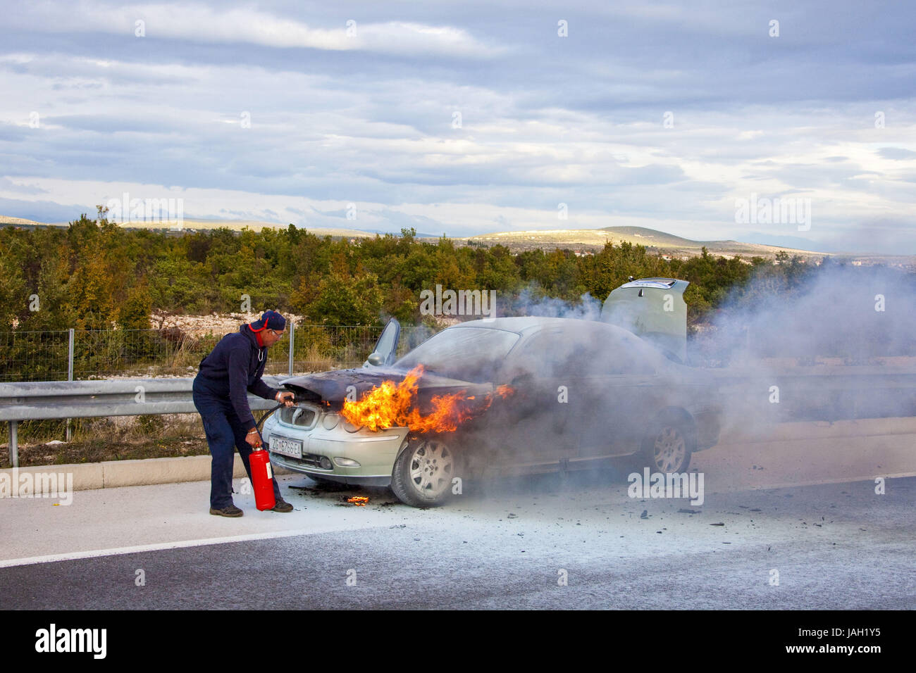 Croatia,burning car by the roadside,man with fire extinguisher Stock ...