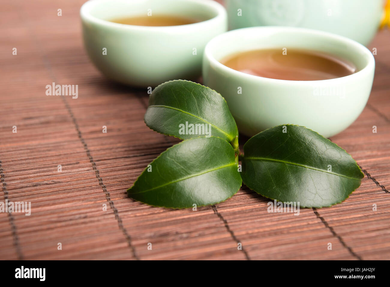 A cup of green tea with freh leaves Stock Photo - Alamy