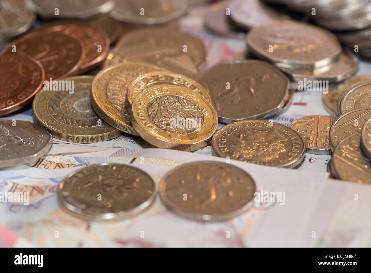 Piles of Great British currency including cash and coins in sterling ...