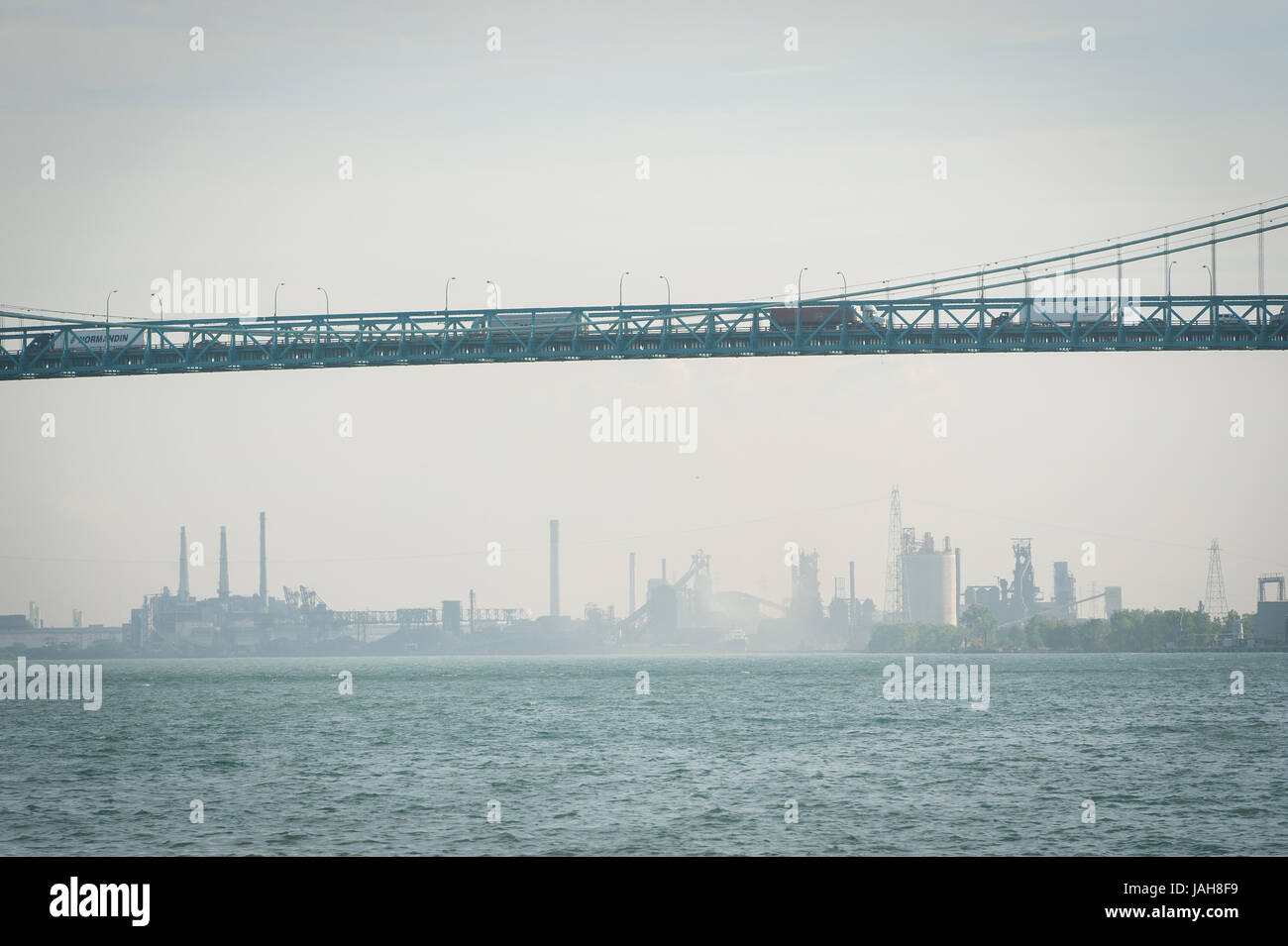 Traffic makes its way over the Detroit River on the Ambassador Bridge ...