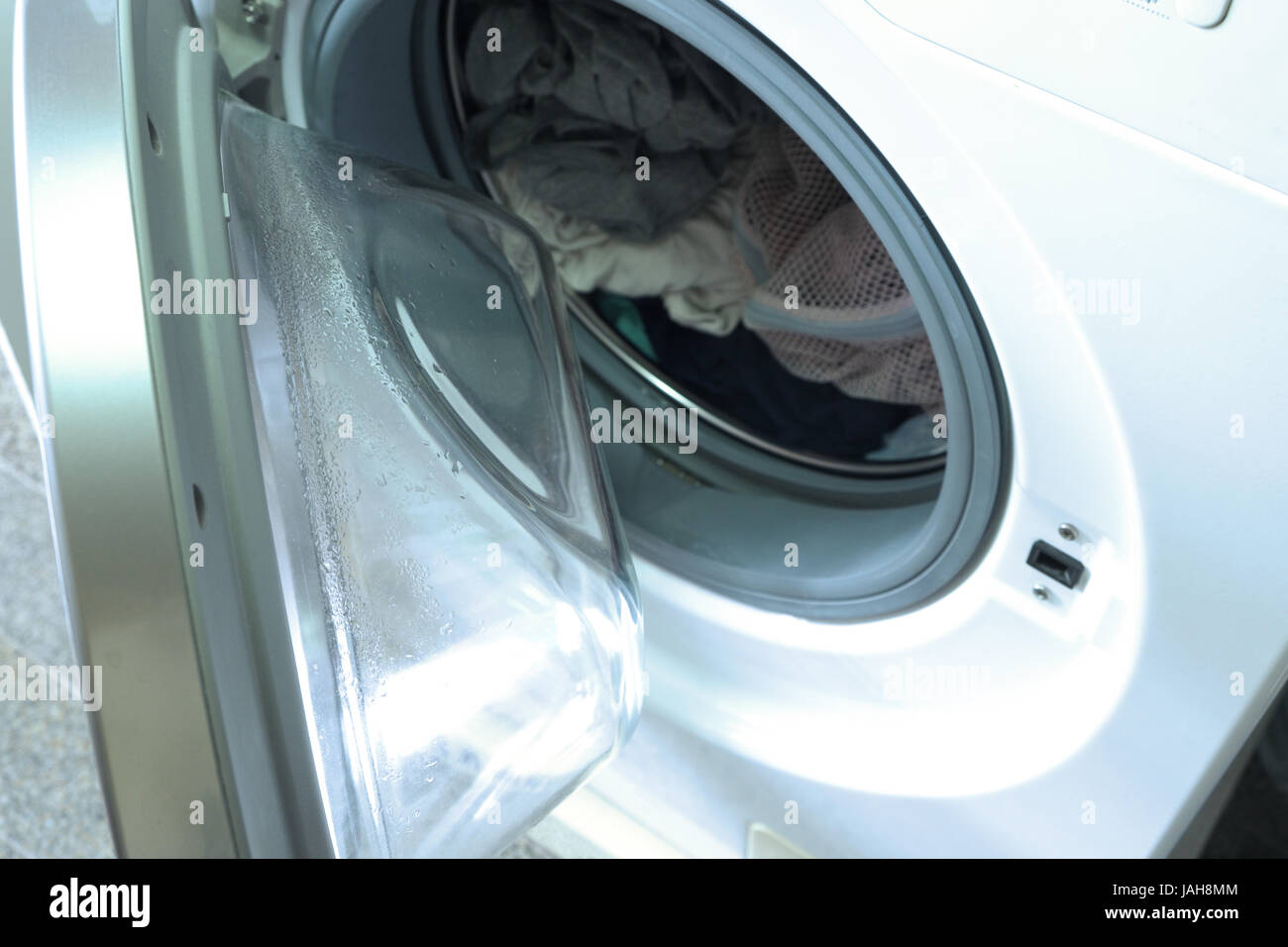 Washing machine, open door, loaded with clothes. Close up Stock Photo ...