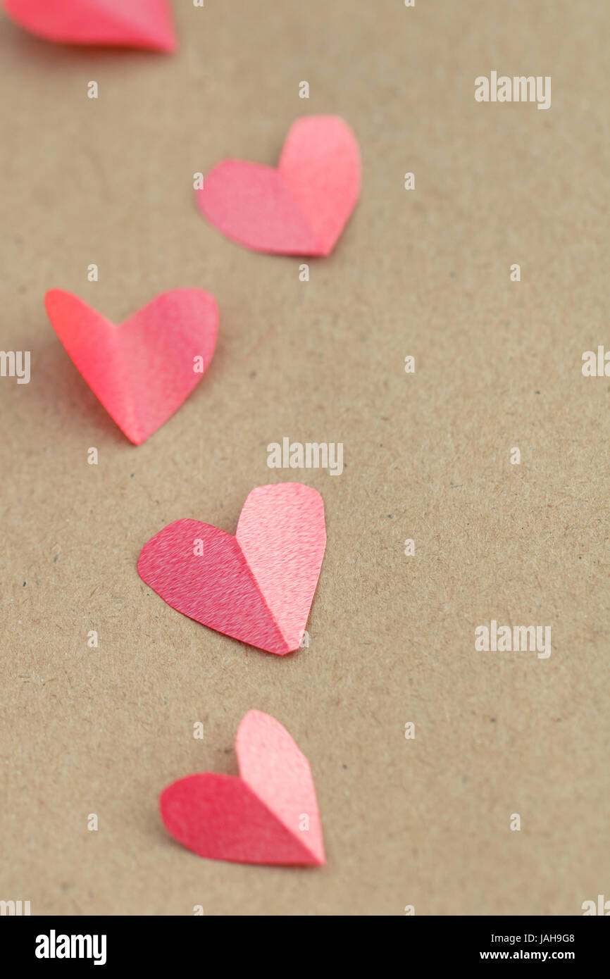 Paper hearts on a craft paper background Stock Photo - Alamy
