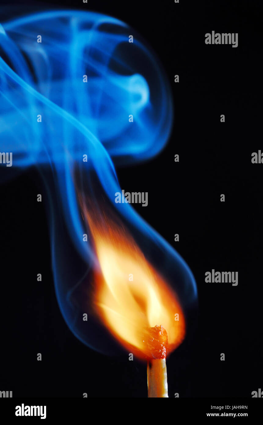 lighting a match on black background Stock Photo - Alamy