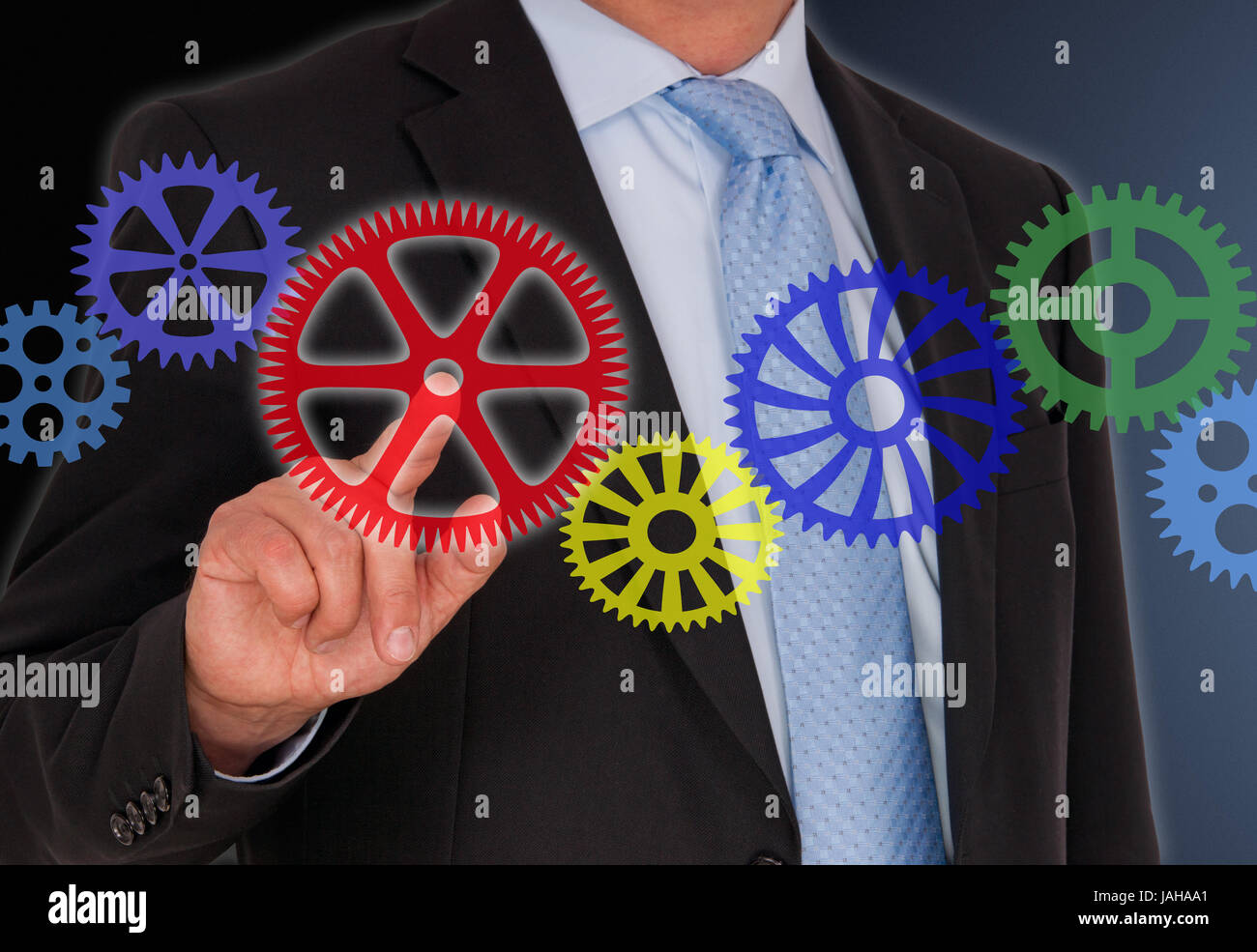 Businessman turning wheels Stock Photo - Alamy