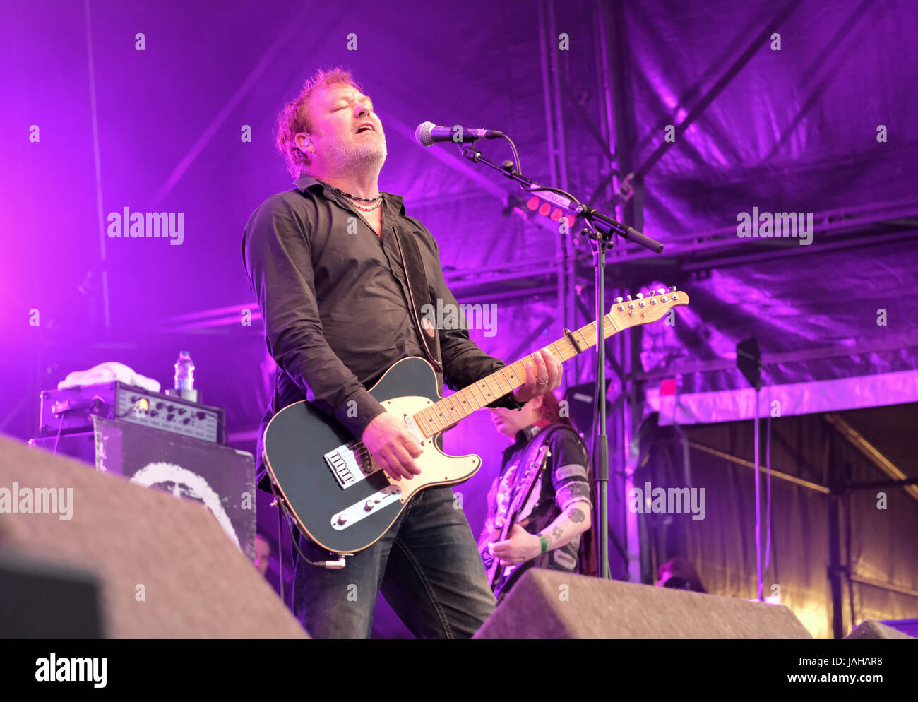 Mark Chadwick of The Levellers performing at Wychwood Festival ...