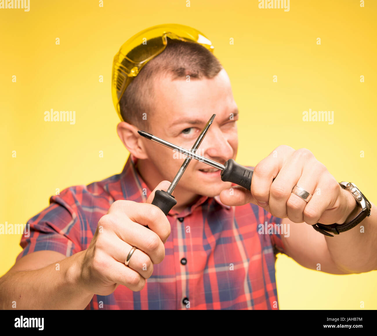 cheerful man with a tool in the hands Stock Photo - Alamy