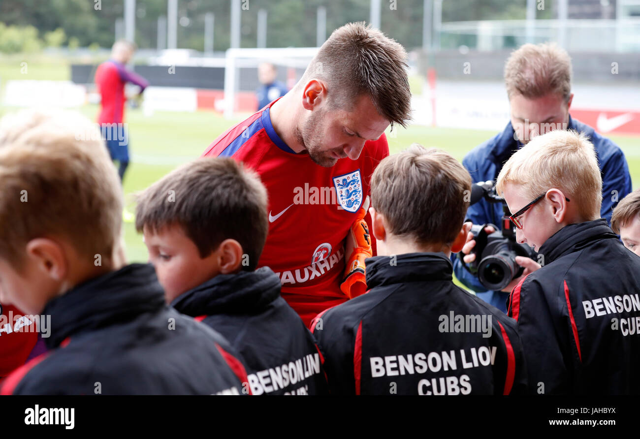 England's Tom Heaton signs autographs after the training session at St ...