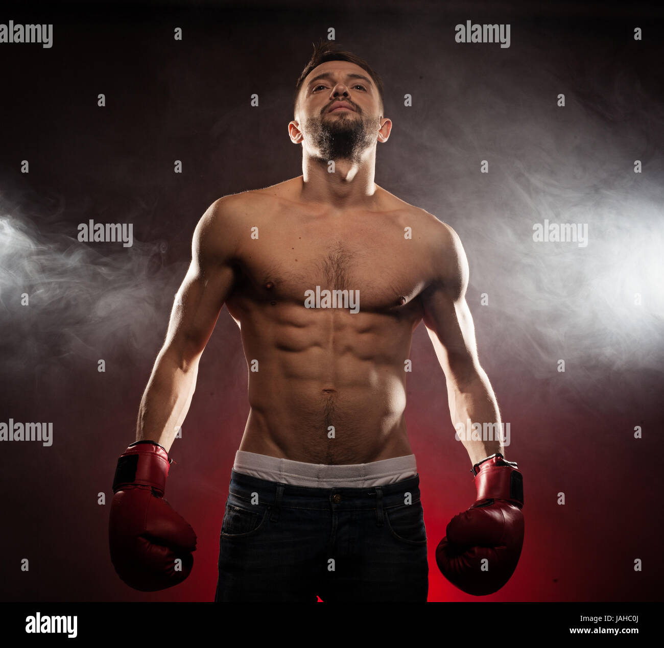 Low angle view of a shirtless fit caucasian boxer showing the abs and ...